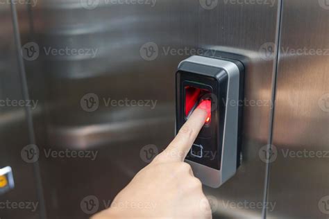 Woman Using Finger To Fingerprint Scanner In Elevator Security System In Office And Apartment