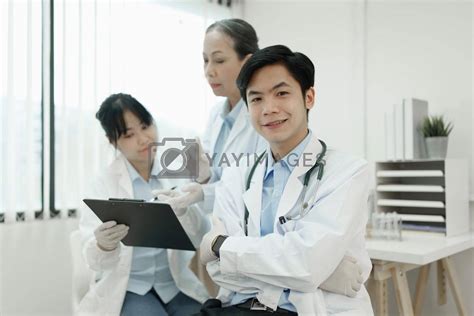 Group Of Science Researchers Analysing Together At Medical Science Laboratory By Itchaznong