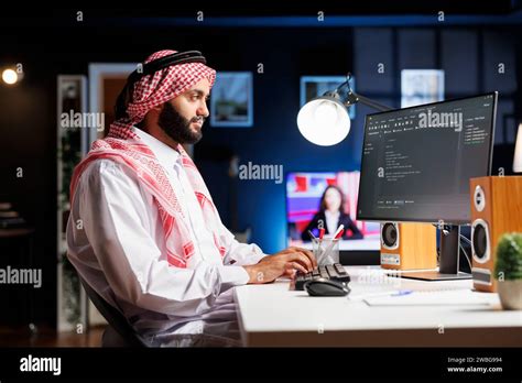 Side View Of Muslim Developer Writing Code On Desktop Pc Parsing
