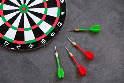 Dartboard And Dart Arrows Standing On Black Ground Dart Arrow Stuck And Dart Board Stock Image