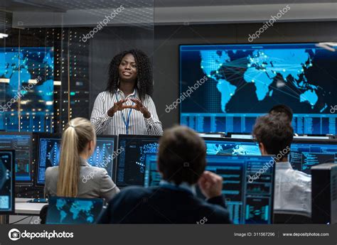 chief project engineer holds briefing for a team of scientists that are building machine