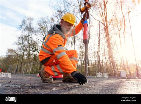 Surveyor Operating His Touch Screen Controller Instrument During