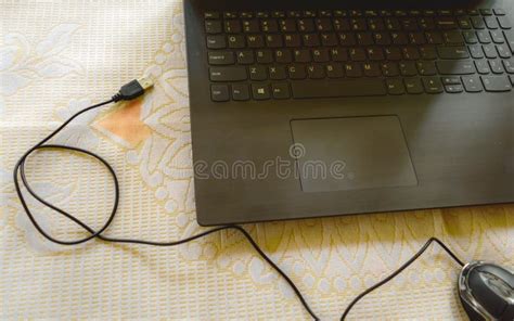 Computer Mouse Connection Plug In Rolled And Clipped And Placed In Front Of The Laptop Keyboard