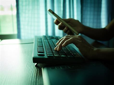 Premium Photo Hacker Typing Keyboard With Mobile Hack Crypto Criminal