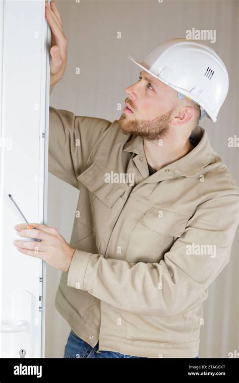 Man Measuring Window Prior To Installation Of Roller Shutter Outdoors Stock Photo Alamy