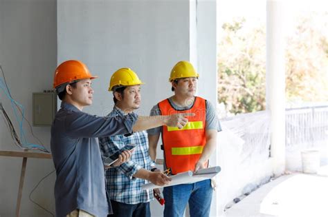 Construction Concept Of Engineer And Architect Working With Construction Model And Blueprint At