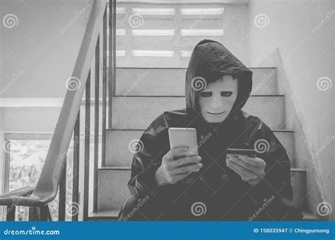 Anonymous Computer Hacker In White Mask And Hoodie Hacker Holding