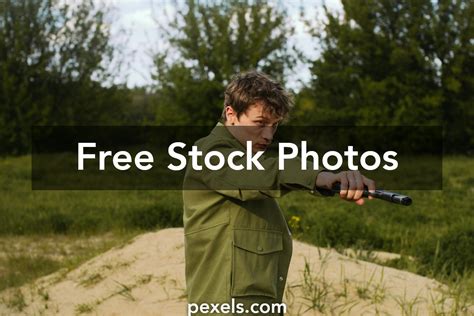 People Holding Guns Photos Download The Best Free People Holding Guns