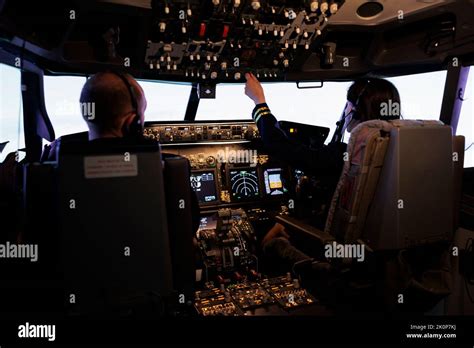 Woman Copilot Assisting Captain To Takeoff And Fly Airplane Using Buttons On Dashboard Command