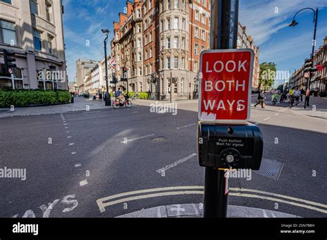 A Traffic Light With A Push Button For Pedestrians To Cross The Street