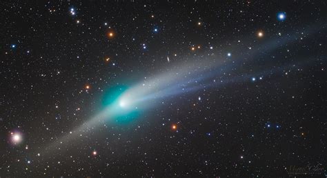 Comet Ztf Featuring Two Ion Tails While Crossing In Front Of A Galaxy In A Colorful Starfield