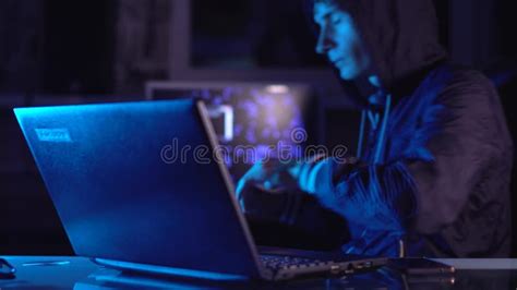 Hacker Typing Program Code While Committing A Cybercrime Hacking A System Firewall In The Dark