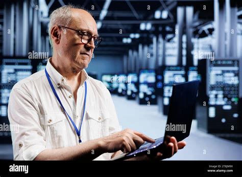 Senior It Developer Inspects Supercomputers In Data Center Ensuring