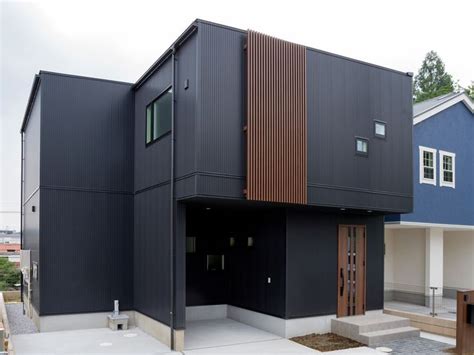The House Is Black And Has Wooden Slats On It