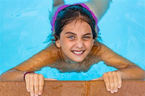 Premium Photo Portrait Of Smiling Girl In Swimming Pool