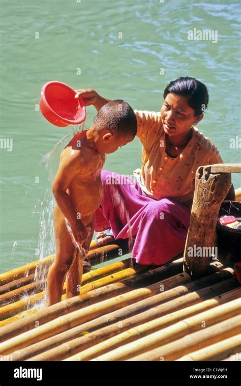 Woman Bathing Son At Riverside In Dein Inle Lake Myanmar Burma