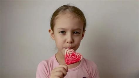 A Cute Girl Sucks A Big Red Lollipop Is Stock Video Pond