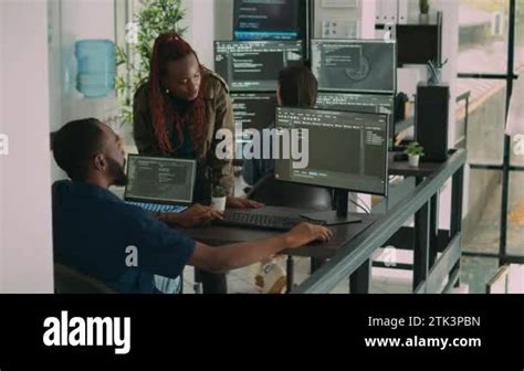African American Team Of Developers Talking About Source Code Running