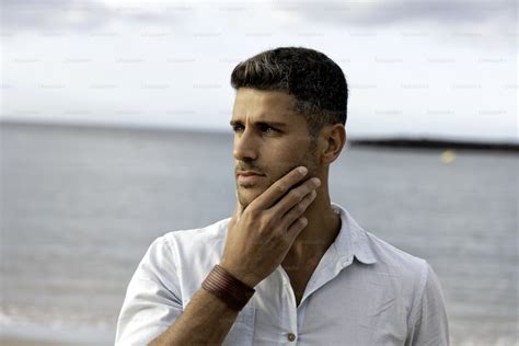 해안에서 야외에서 포즈를 취하는 잘생긴 젊은 이탈리아 남자의 초상화 사진 Unsplash의 스페인 이미지