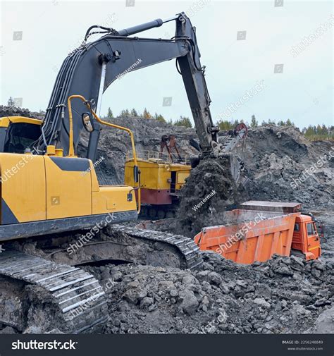 Modern Excavator Loading Soil Into Truck Stock Photo 2256248849 Shutterstock