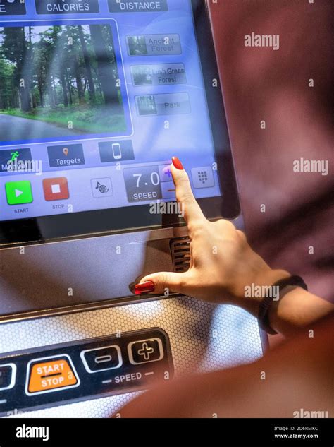 Woman Changing The Speed Of Treadmill In The Gym Stock Photo Alamy