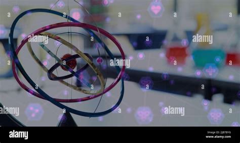 Digital Composite Image Of Network Of Connection With Interface Icons Against Model Of Atom