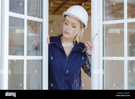 Female Engineer Builder Fixing A Window Stock Photo Alamy