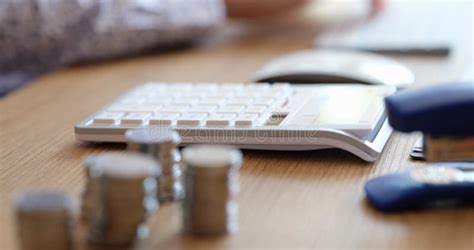 Female Hands Using Calculator Carry Out Calculation For Laptop