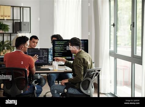 Software Developers Discussing Programming Code And Planning How To