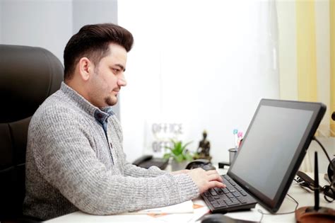 Premium Photo A Young Employee Working On Computer