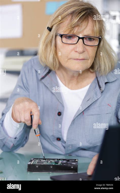Female Unscrewing A Back Of A Laptop Stock Photo Alamy