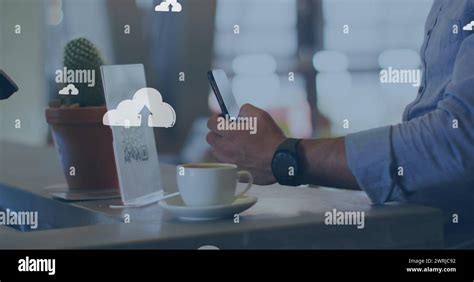 Cloud Icons Against Mid Section Of A Caucasian Man Scanning Qr Code With His Smartphone At A