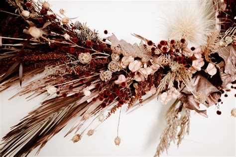 흰 벽에 나뭇잎과 붉은 꽃이 있는 둥근 나뭇가지 화환의 근접 촬영 0명에 대한 스톡 사진 및 기타 이미지 0명 가을 겨울