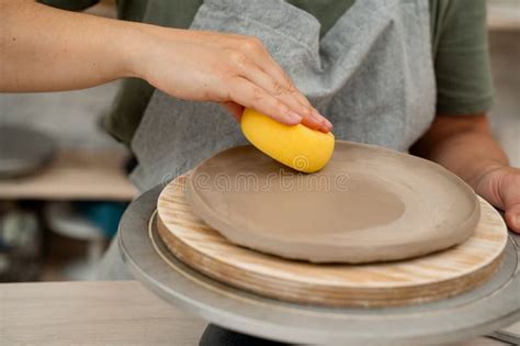 Ceramics Workshop Applying More Moisture On Clay Products Smoothing Clay With A Sponge Stock