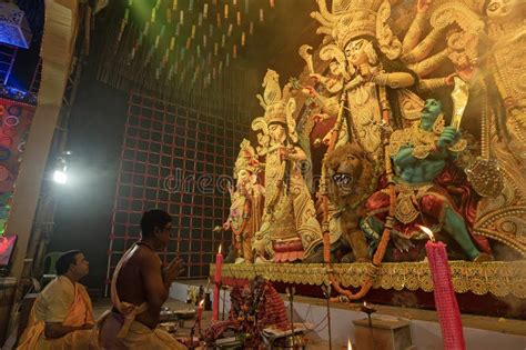 Hindu Priests Praying And Worshipping Goddess Durga With Folded Hands