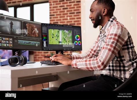 male digital creator editing video montage on post production software