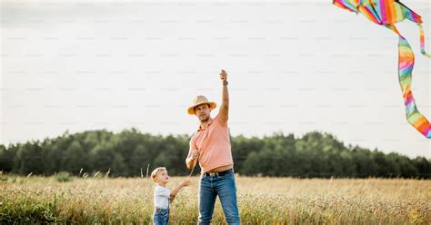 아들과 함께 아버지는 일몰 동안 들판에서 화려한 공기 연을 발사합니다 여름 활동 동안 즐거운 시간을 보내는 행복한 가족의 개념 사진 Unsplash의 아버지와 아들 이미지