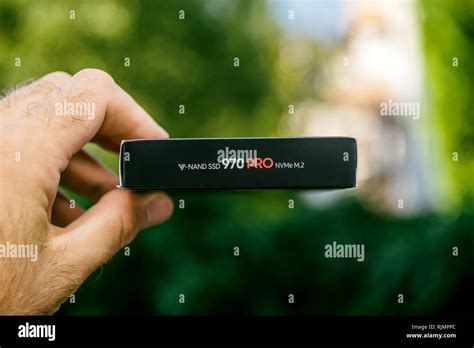 PARIS FRANCE AUG 3 2018 Man Hand Holding Packaging Box Of NVME PCIE SSD Hard Drive Disk