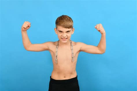 Premium Photo A Small Thin Boy With A Chain Around His Neck Raised