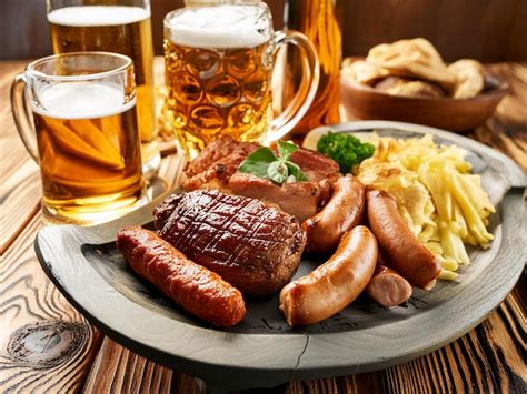 Traditional German Meat Dishes With Vegetable Snacks And Beer Premium Ai Generated Image