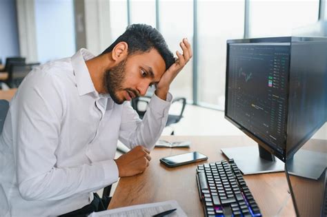 Premium Photo Young Indian Business Man Trader Looking At Computer