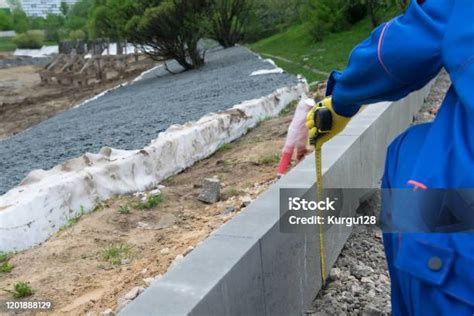 작업자는 저수지 의 해안에 보행자 도로의 건설 중에 테이프 측정으로 연석을 측정 검사자에 대한 스톡 사진 및 기타 이미지 검사자 공학 도로 Istock