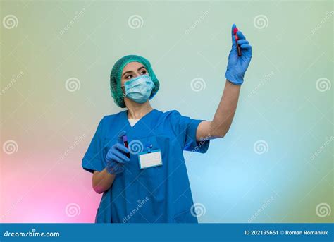 Medical Worker In Protective Costume Holding Red Test Tubes In Hands In