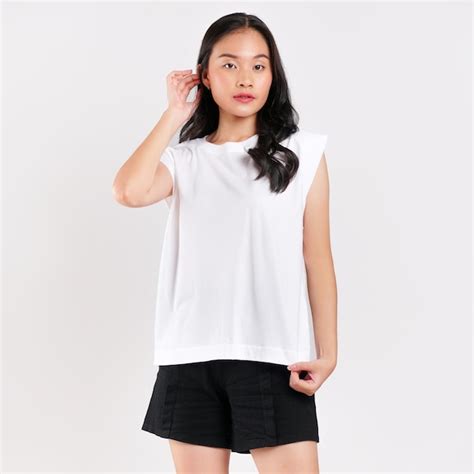 Premium Photo A Woman Wearing A White Top With Black Shorts And A