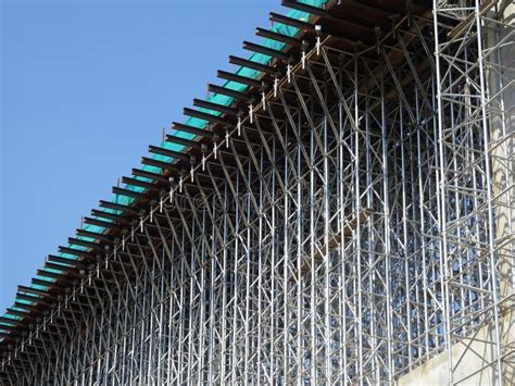 Metal Scaffolding Is Used As A Temporary Structure That Supports Works At The Construction Site