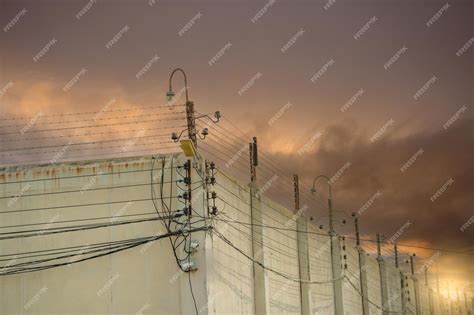 Premium Photo Prison Security Electric Fence And High Concrete Wall