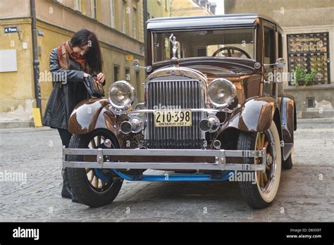 Oldtimer Car Essex Super Six And Young Woman On Old Town In Warsaw