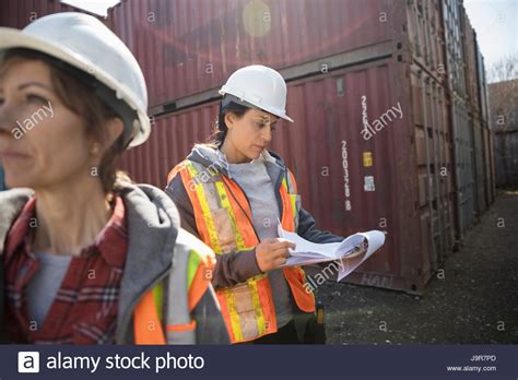 Female Worker With Clipboard In Industrial Container Yard Stock Photo Alamy