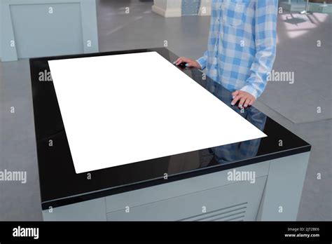 Woman Looking At Interactive White Touchscreen Display Table Kiosk At Exhibition Stock Photo Alamy