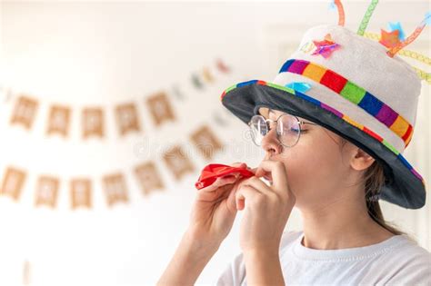 A Festive Girl Inflates A Balloon On Her Birthday Birthday Concept